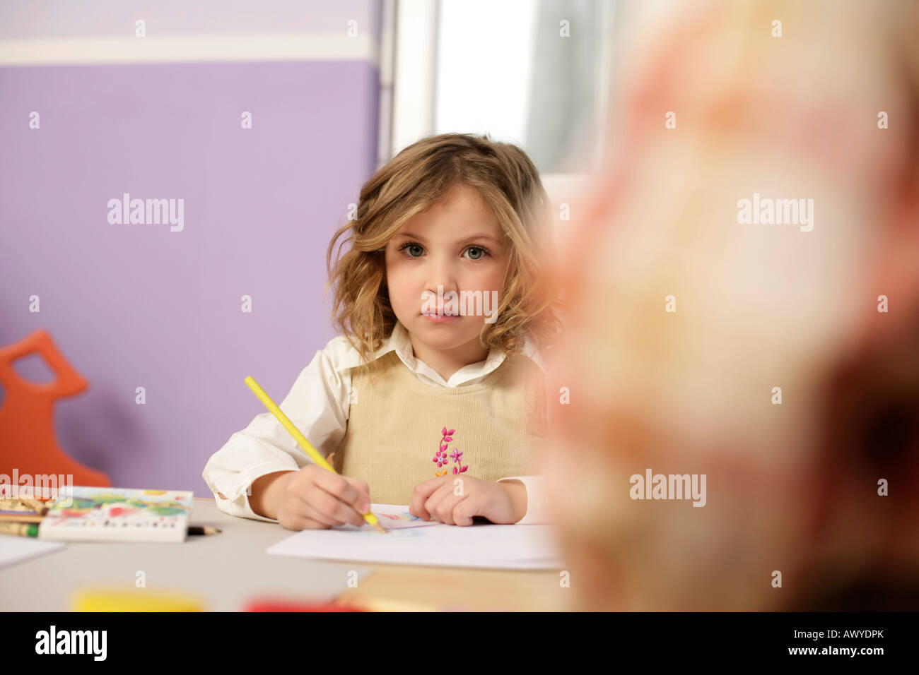 Girl drawing, looking at camera Stock Photo - Alamy