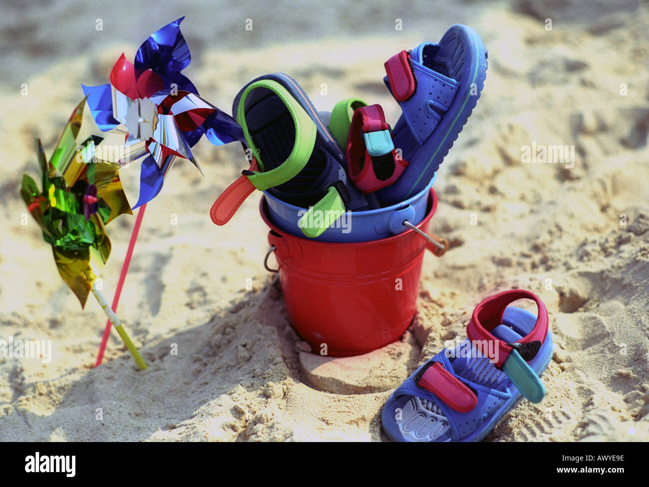 Children s bucket with sandcastle windmills in it on a beach in ...