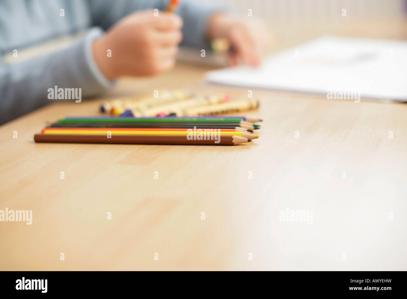 Several crayons lying on a table Stock Photo - Alamy
