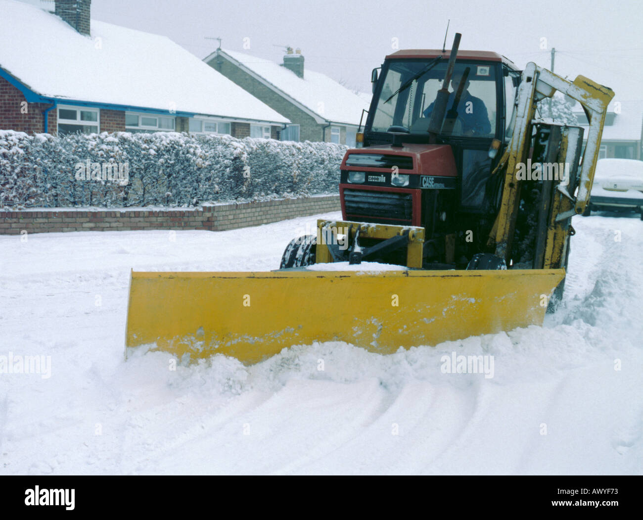 Tractor with a snow plough clearing a road after a snow storm, North ...