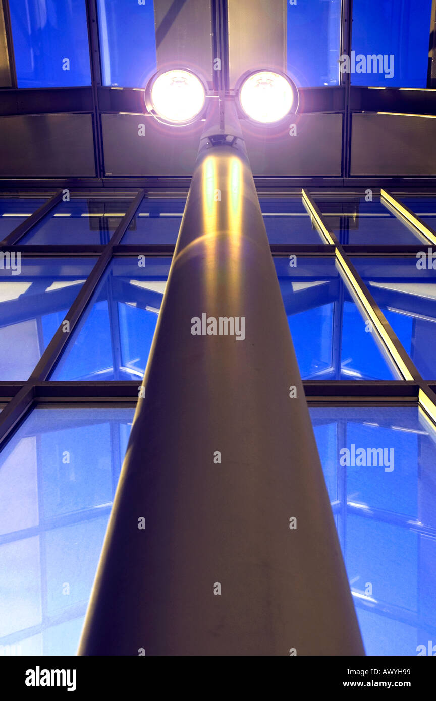 Flood lights on pillar inside glass building Stock Photo - Alamy