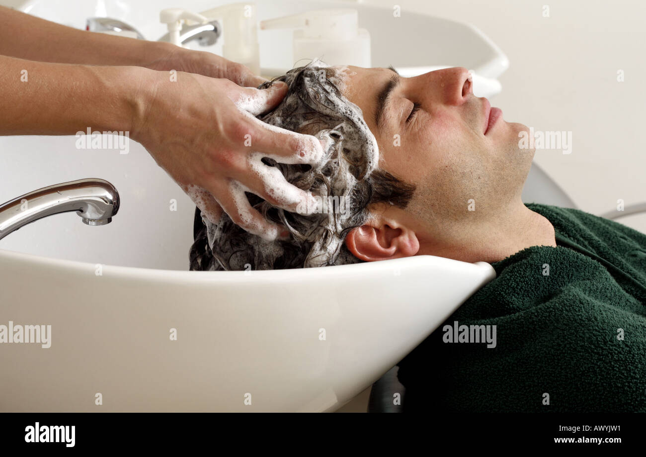Young man having his hair washed at a salon Stock Photo - Alamy
