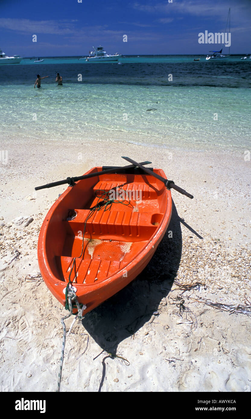 Small orange dinghy on beach with clear tropical water Stock Photo - Alamy