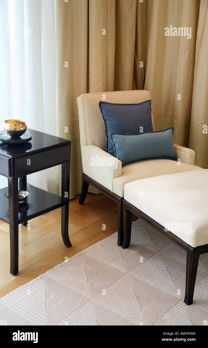 Armchair with sidetable Stock Photo - Alamy