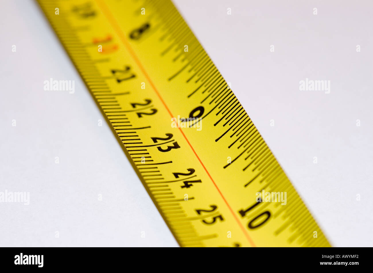 Yellow tape measure showing various measurements and scales Stock Photo ...