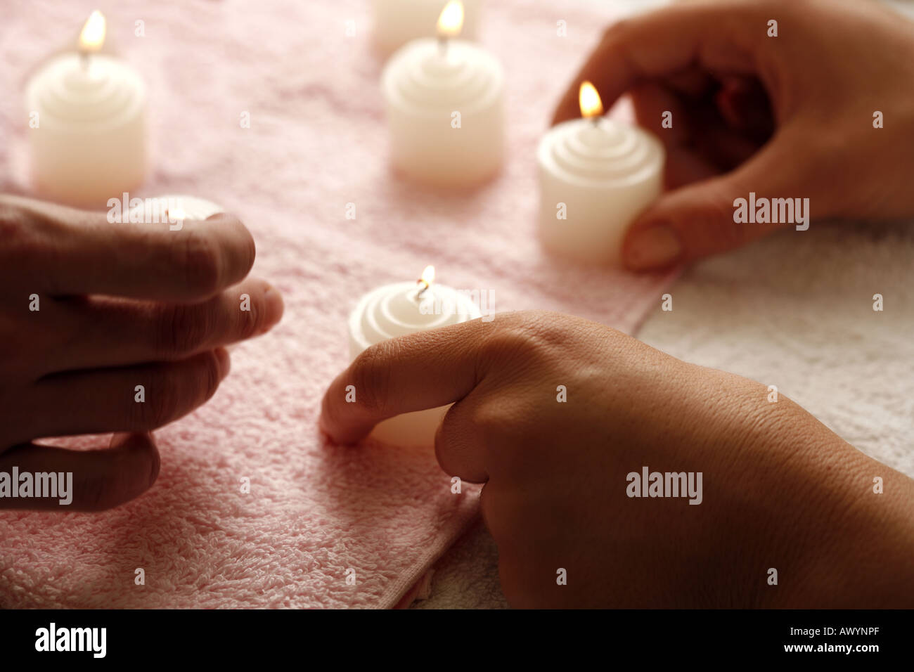 Hands with lit candles Stock Photo - Alamy