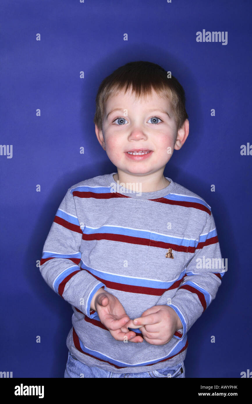 Young boy portrait on a blue background Stock Photo - Alamy