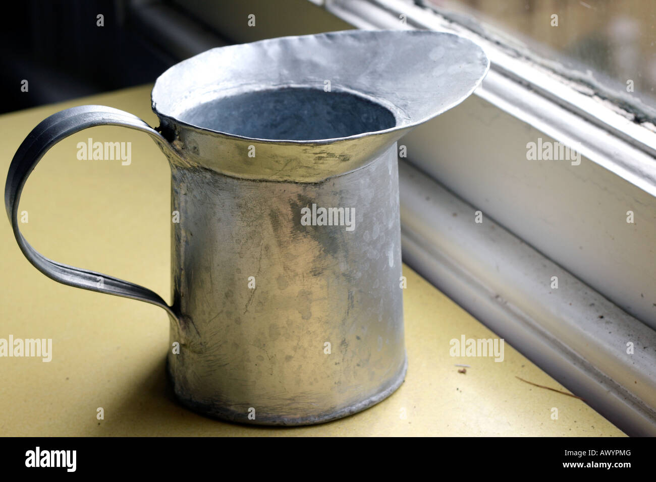 Metal jug on yellow table Stock Photo - Alamy