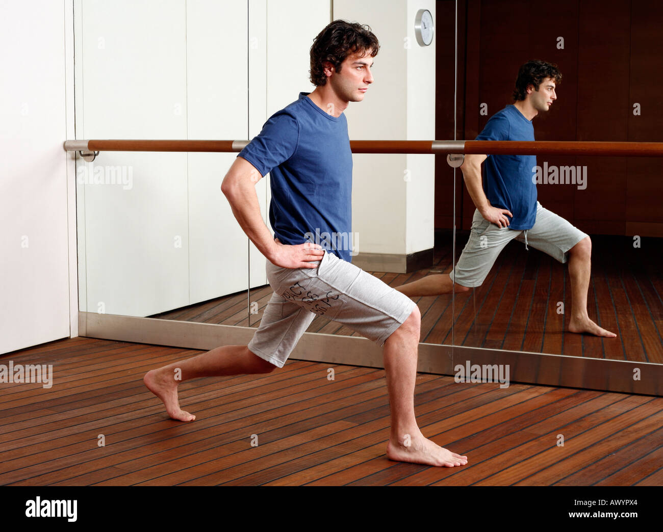 Young man stretching in gym Stock Photo - Alamy