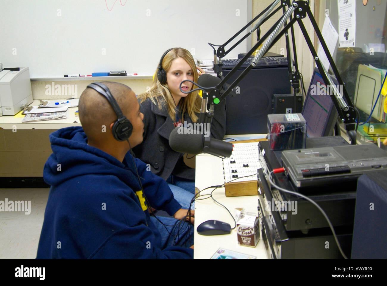 Ethnic male and female high school students learn about radio ...