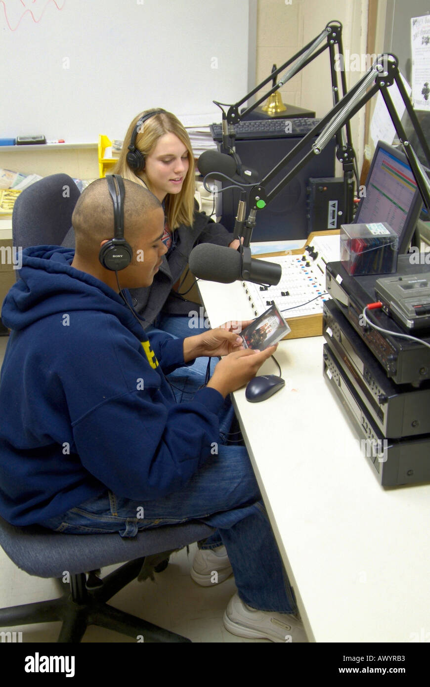 Ethnic male and female high school students learn about radio ...