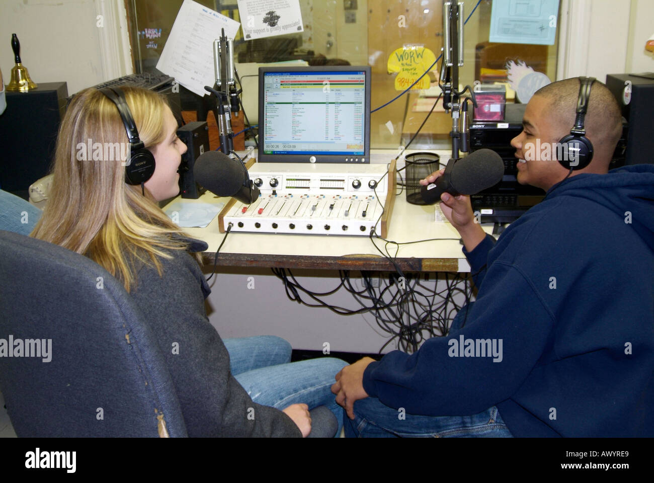Ethnic male and female high school students learn about radio ...