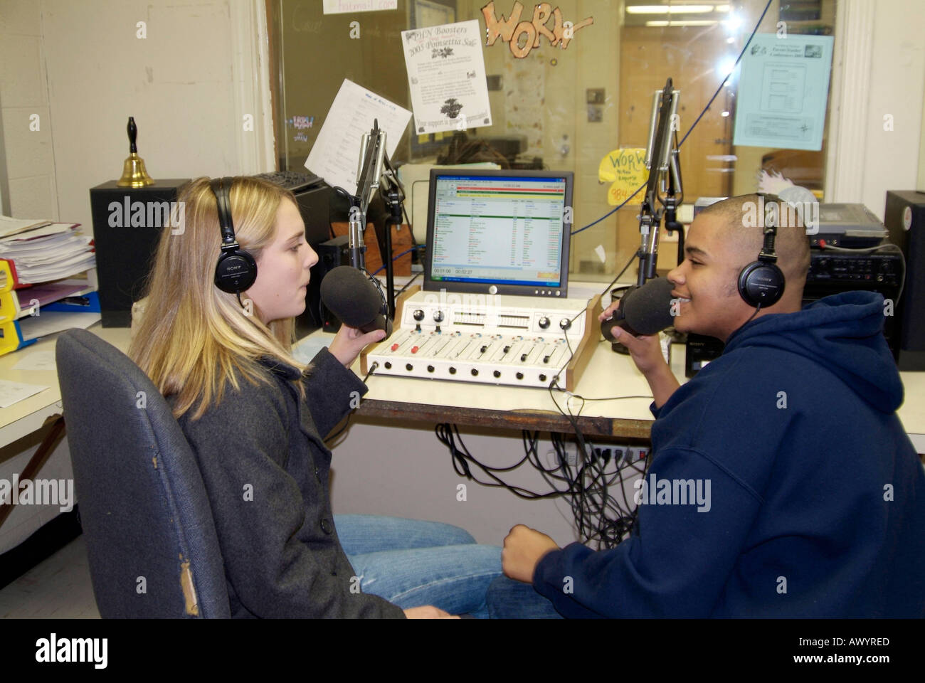 Ethnic male and female high school students learn about radio ...