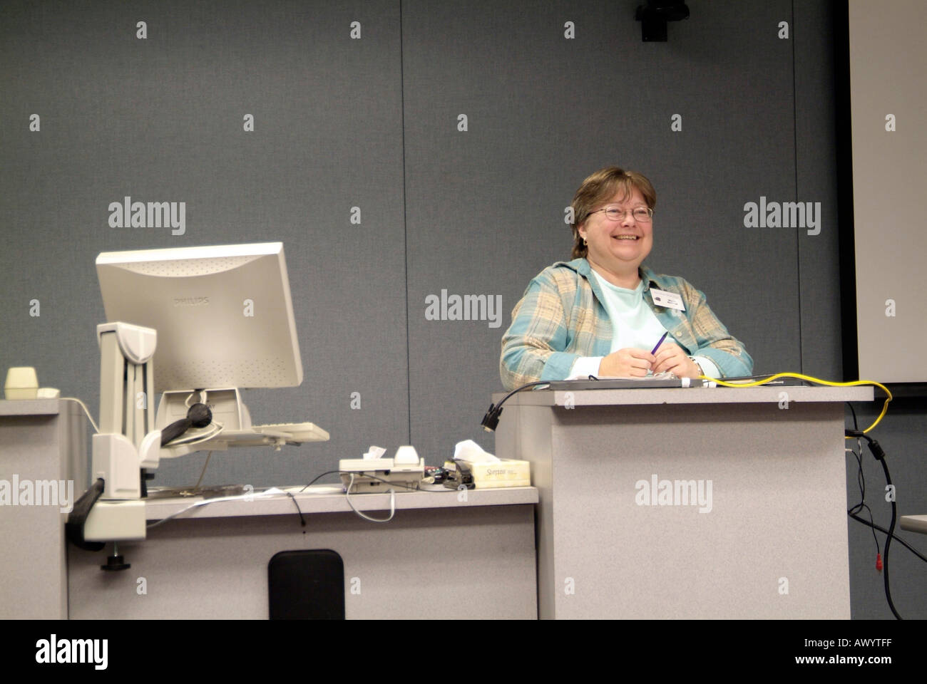 Female presenter gives lecture to business gathering and uses digital ...