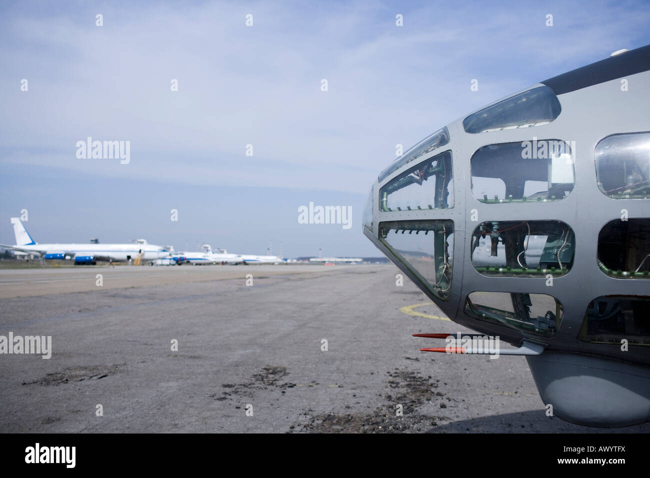 detailed front part of a military airplane landed on a runway and ...