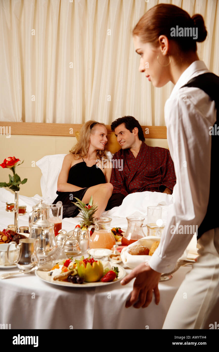 Couple having room service breakfast in hotel room Stock Photo - Alamy