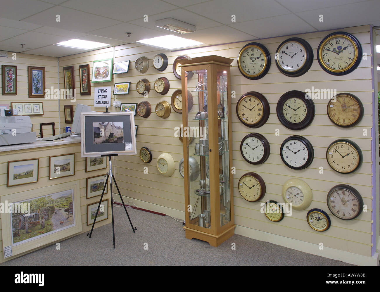 Clocks and pictures on display in art shop Stock Photo - Alamy