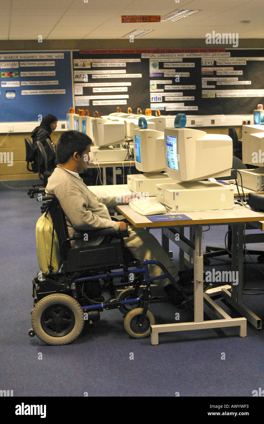 Male Student in wheelchair working at computer at 6th form college GB ...