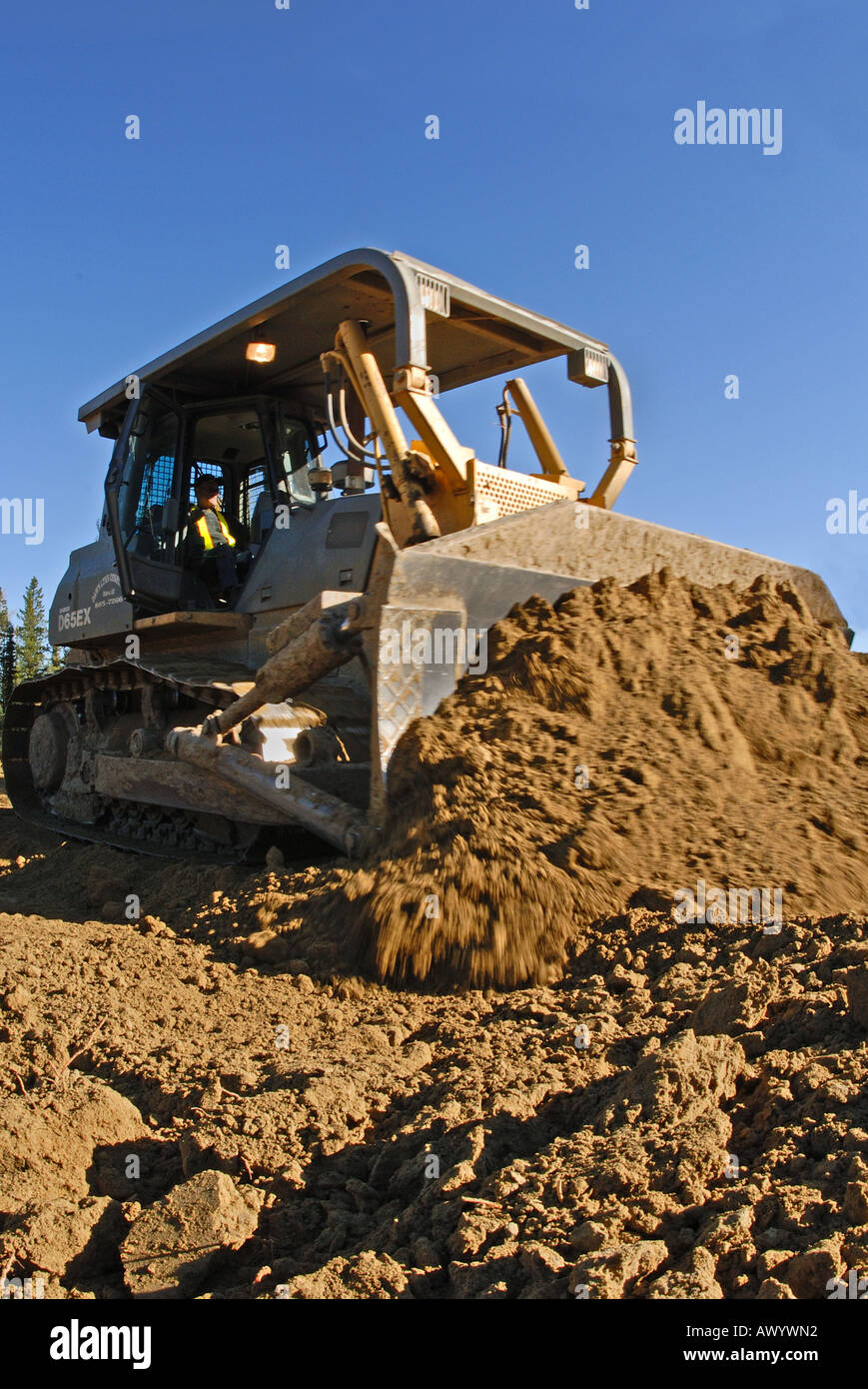 Buldozer leveling earth Stock Photo - Alamy