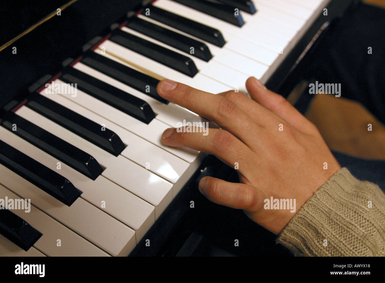 Piano keyboard with students hand Stock Photo - Alamy