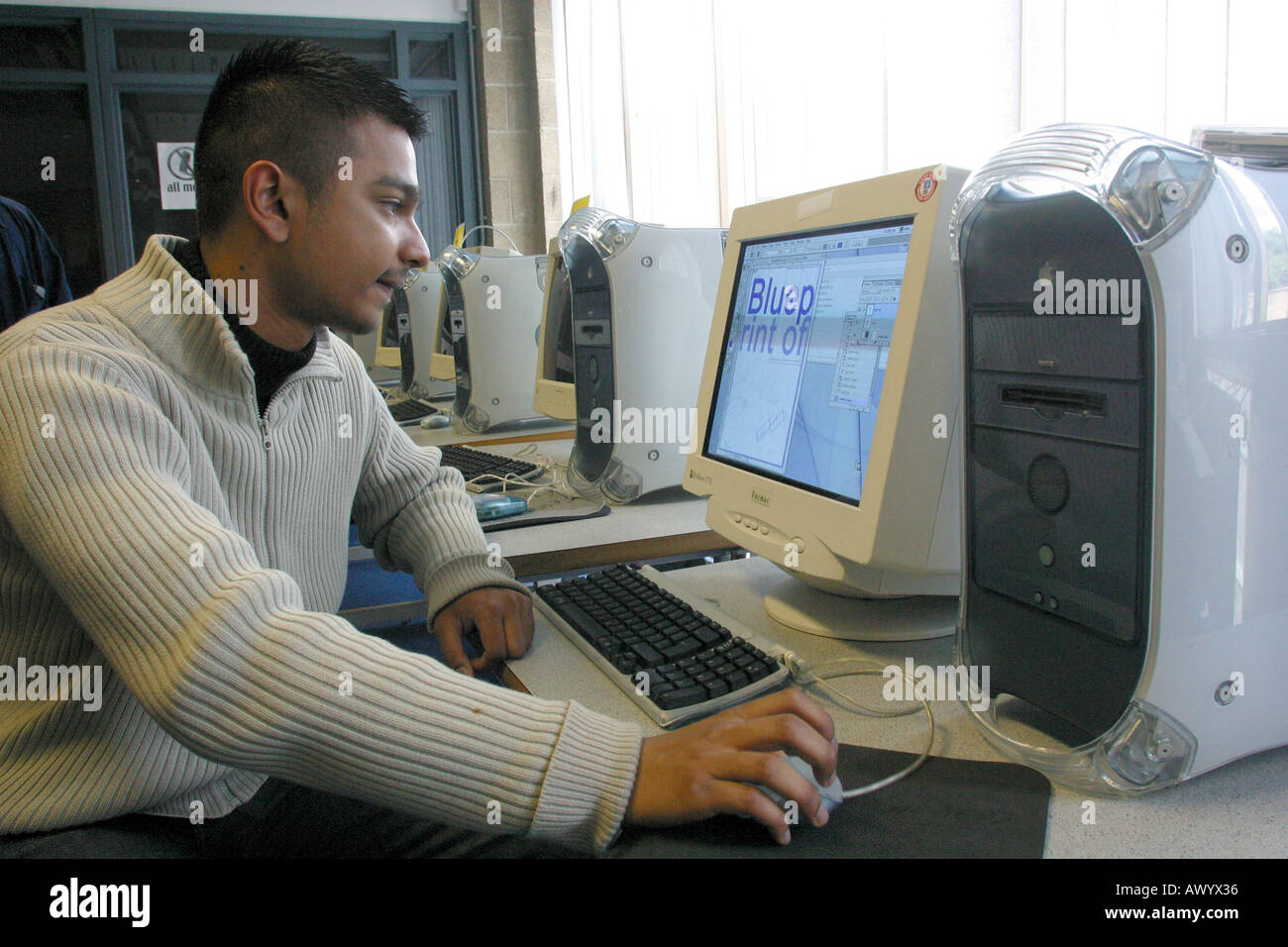 Student with apple computer studying in 6th Form college Stock Photo ...