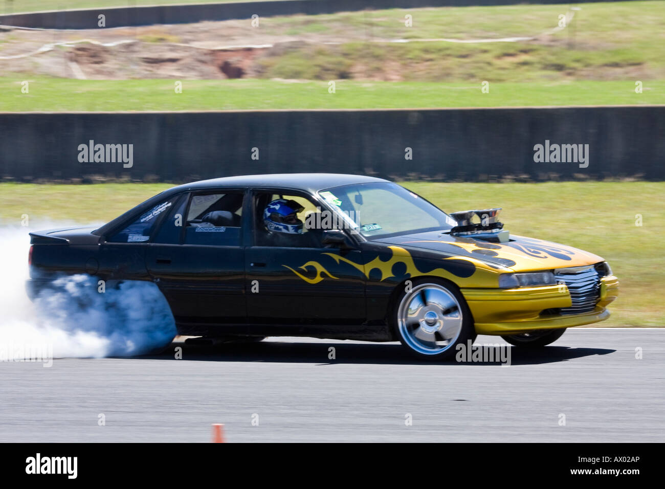 A car burning rubber during a drifting competition on a racetrack Stock ...