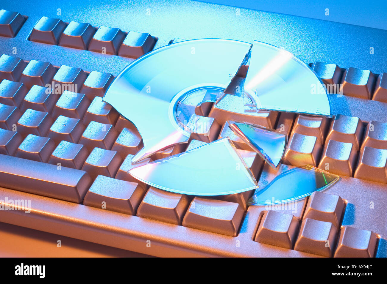 Broken CD on Computer Keyboard Stock Photo - Alamy