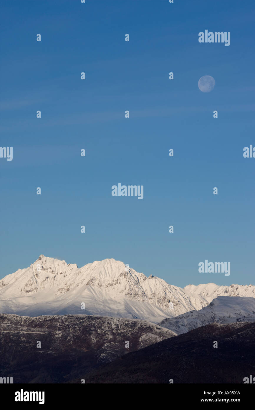 USA Alaska Full moon above Chugach Range mountain peaks in early winter ...