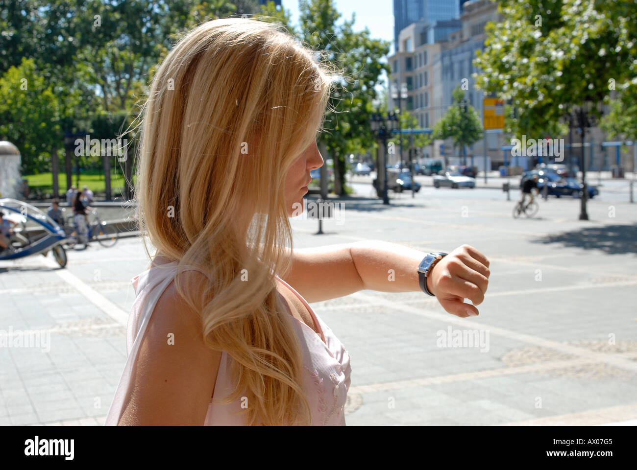 young girl taking a look at her watch Stock Photo - Alamy