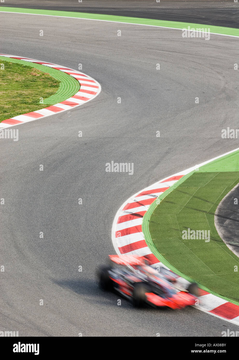 Formula 1 Race car speeds through double bend curve in racetrack Stock ...