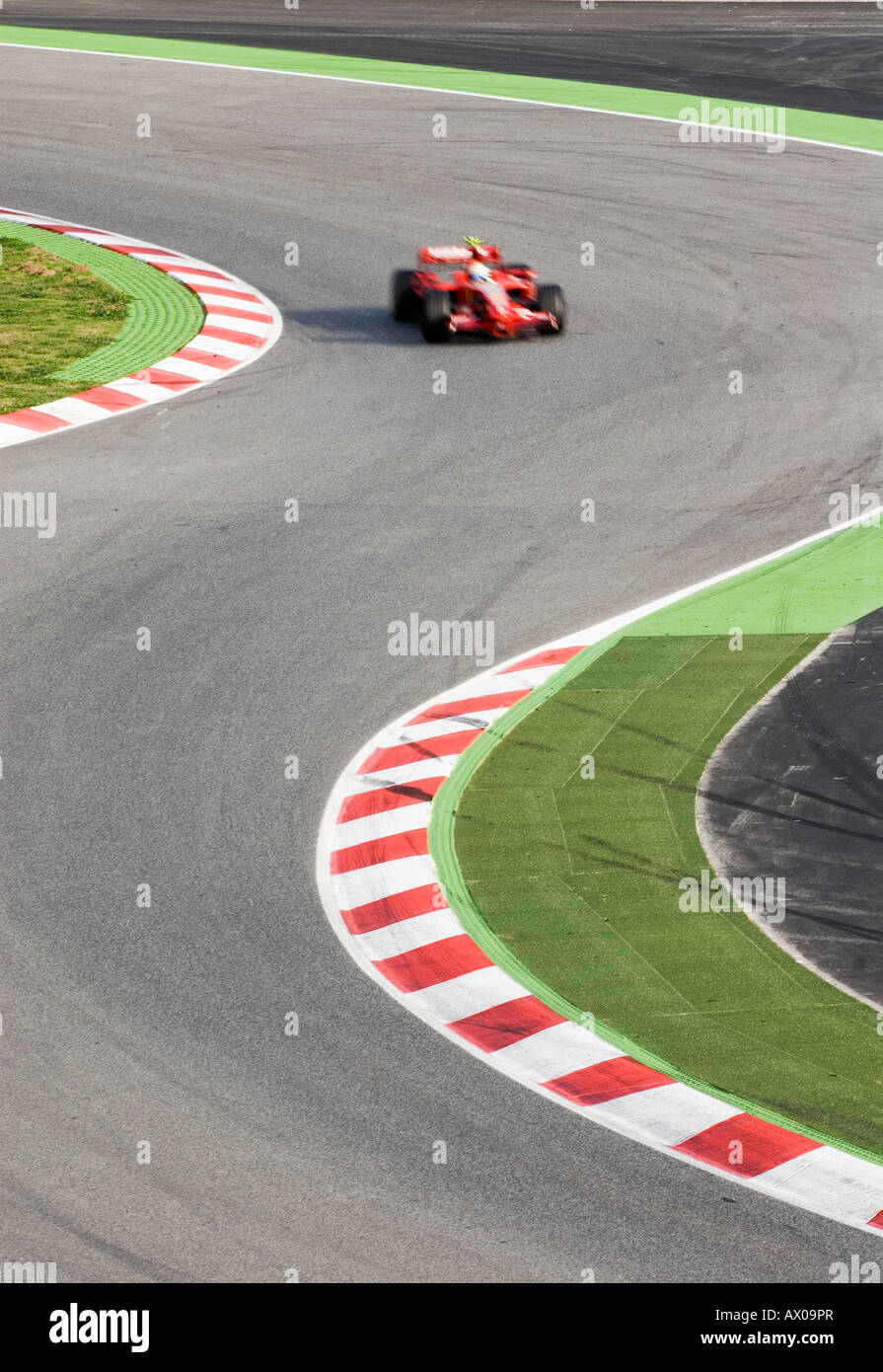 Formula 1 Racecar speeds through double bend curve in racetrack Stock ...