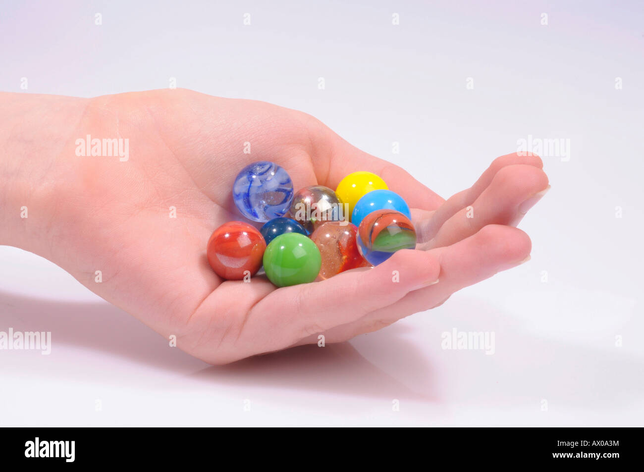 Marbles in a child's hand Stock Photo - Alamy