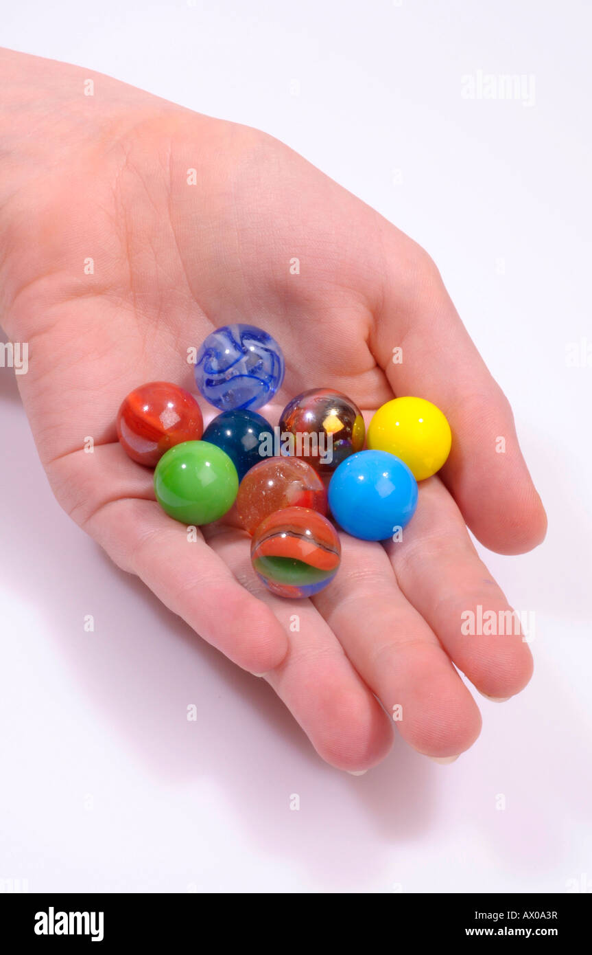 Marbles in a child's hand Stock Photo - Alamy