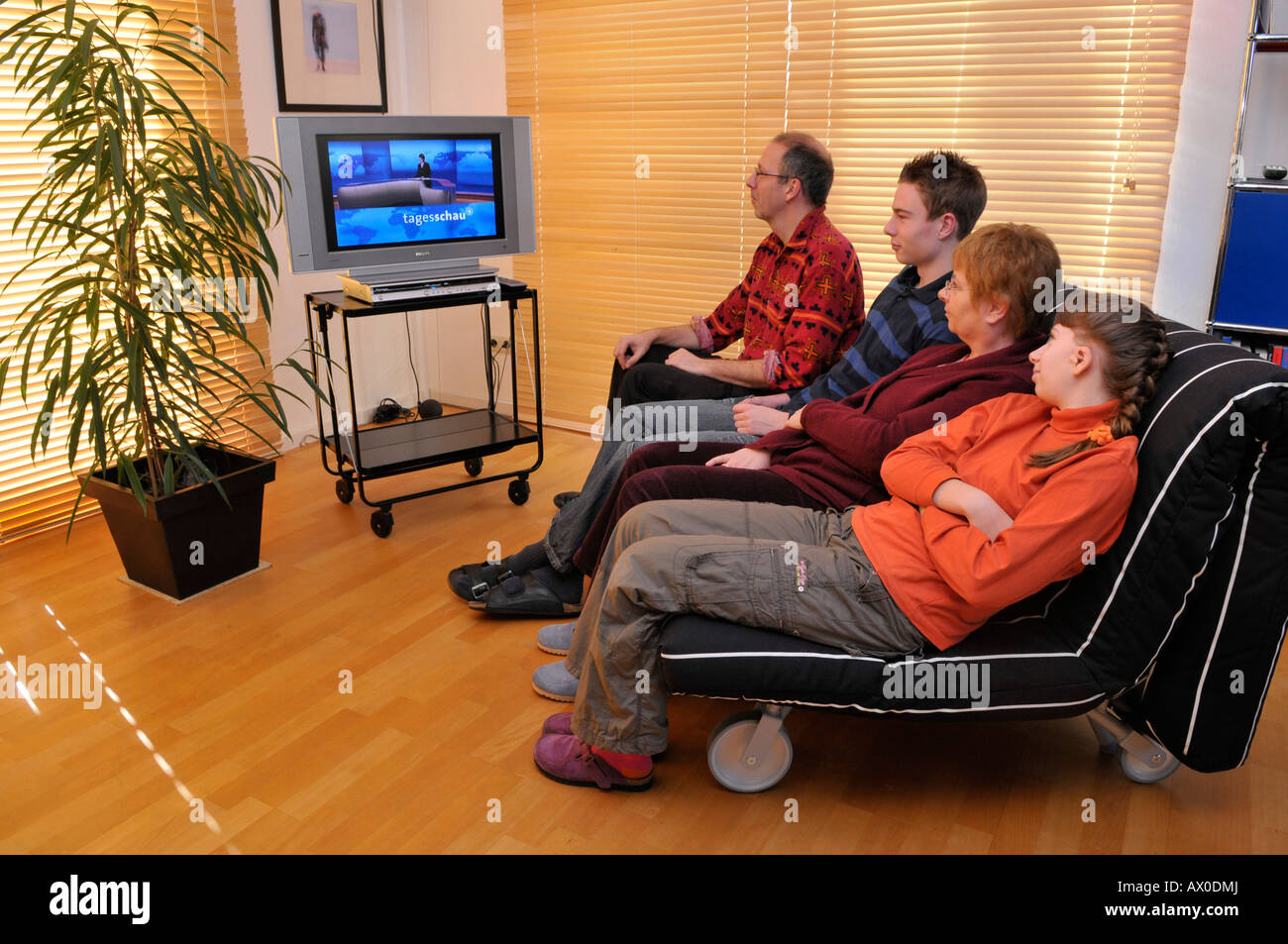 Woman sitting on couch closing hi-res stock photography and images - Alamy