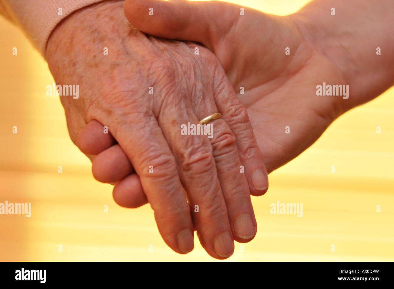 Woman younger man holding hands hi-res stock photography and images - Alamy