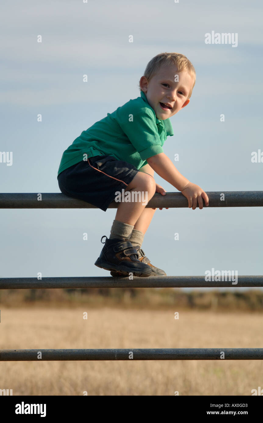 Young boy climbing gate Marloes Sands Stock Photo - Alamy
