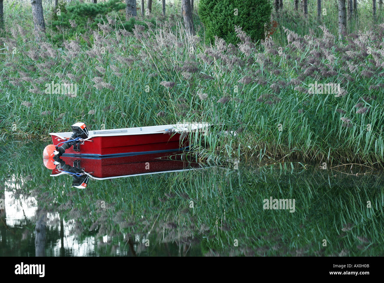Small red motor boat in a river in Gotland Sweden Stock Photo - Alamy
