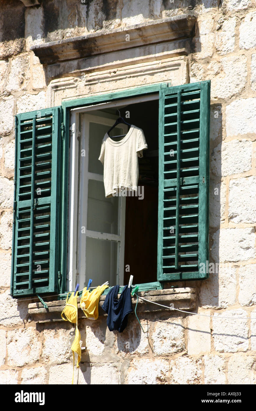 Green shuttered open window with laundry Stock Photo - Alamy