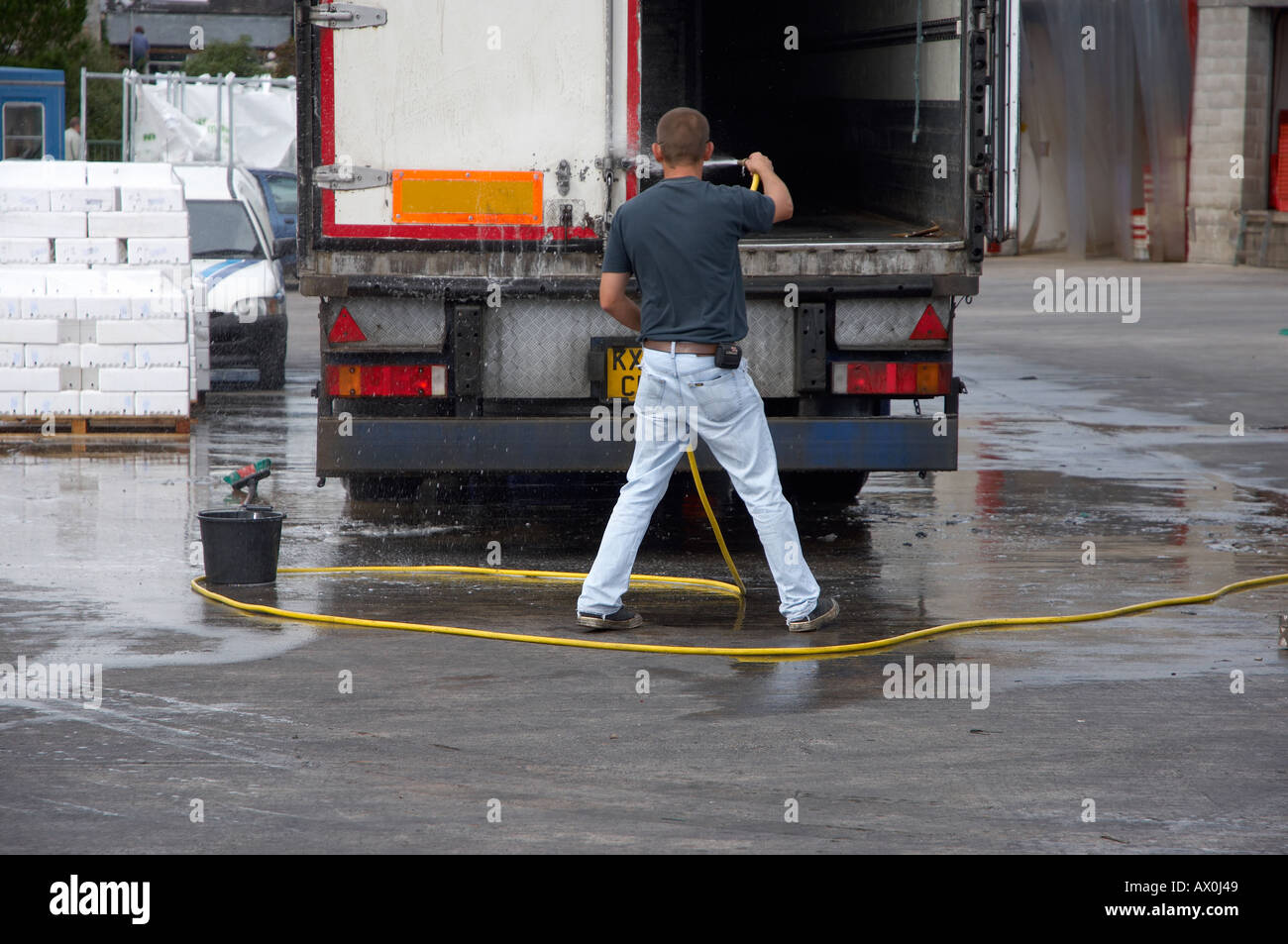 Lorry driver washing his lorry Stock Photo - Alamy