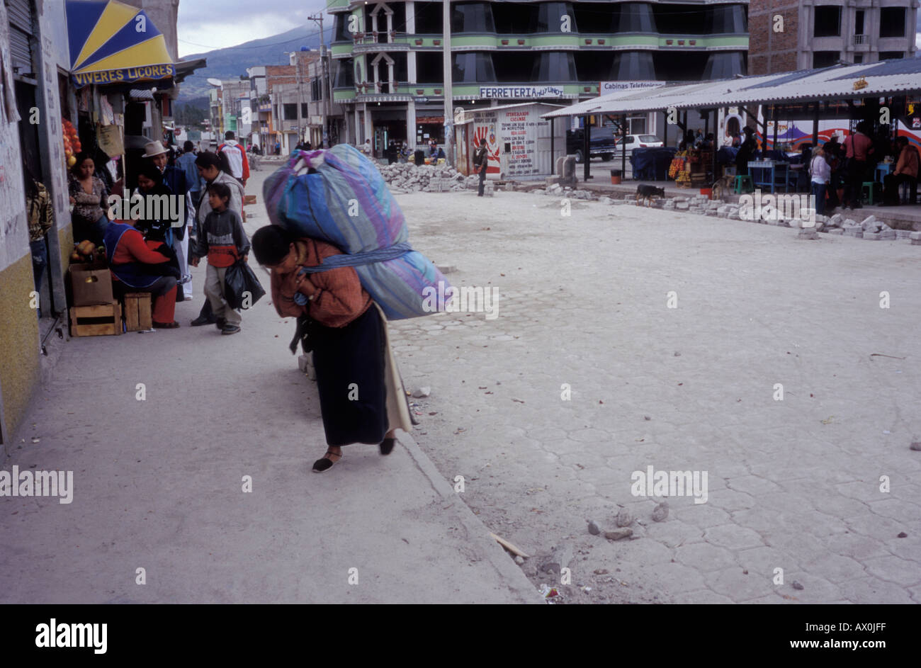 Woman carrying a heavy bag hi-res stock photography and images - Alamy