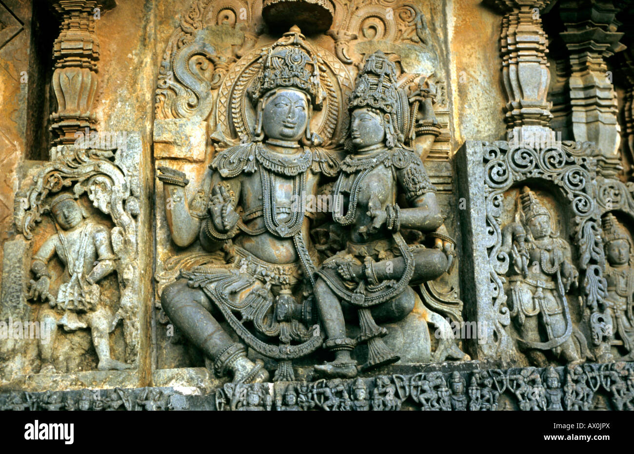Stone relief of the divine couple Shiva and Parvati, Hoysaleshvara Temple, Halebid, Karnataka ...
