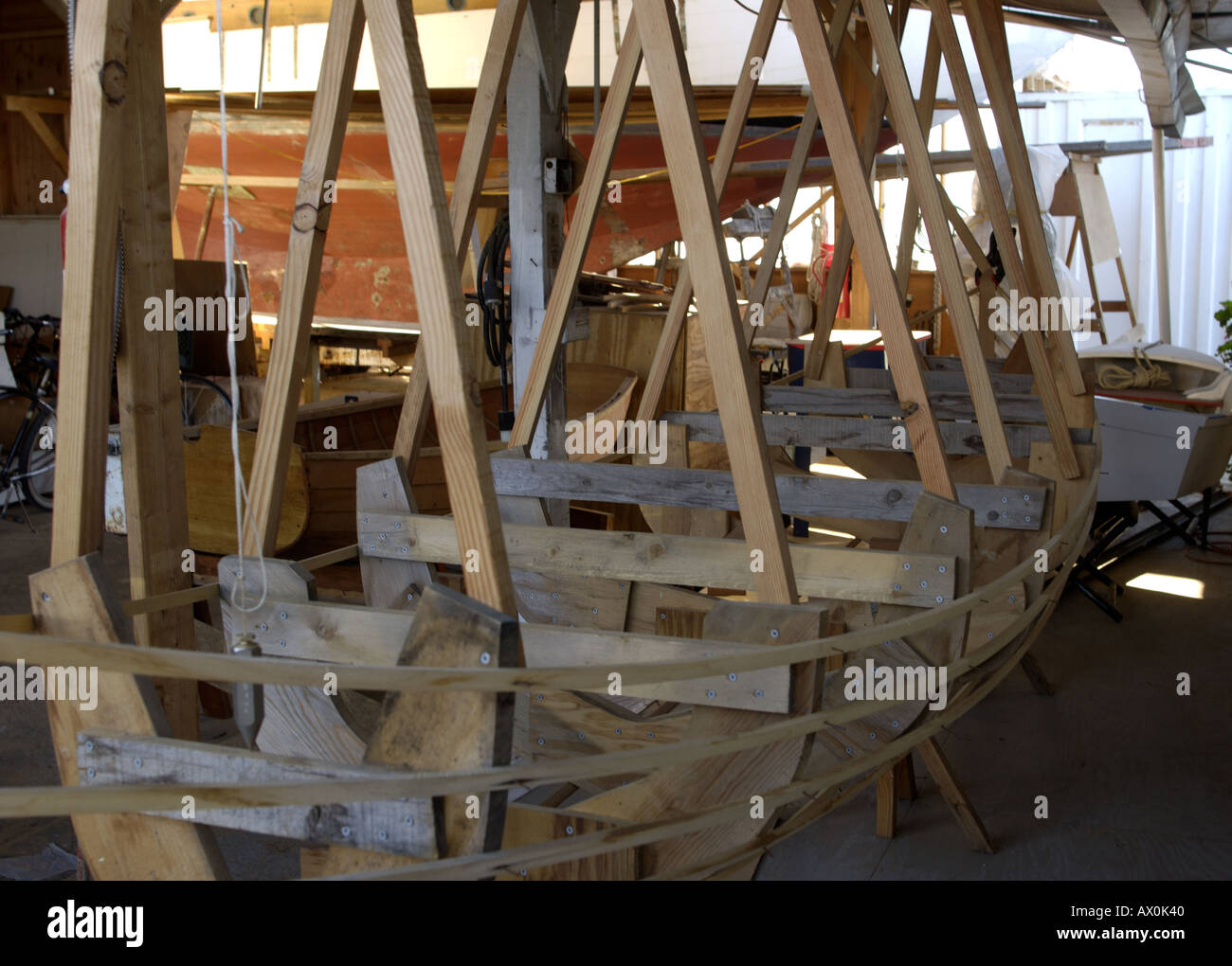A frame of a wood boat in progress of being built in the workshop of ...