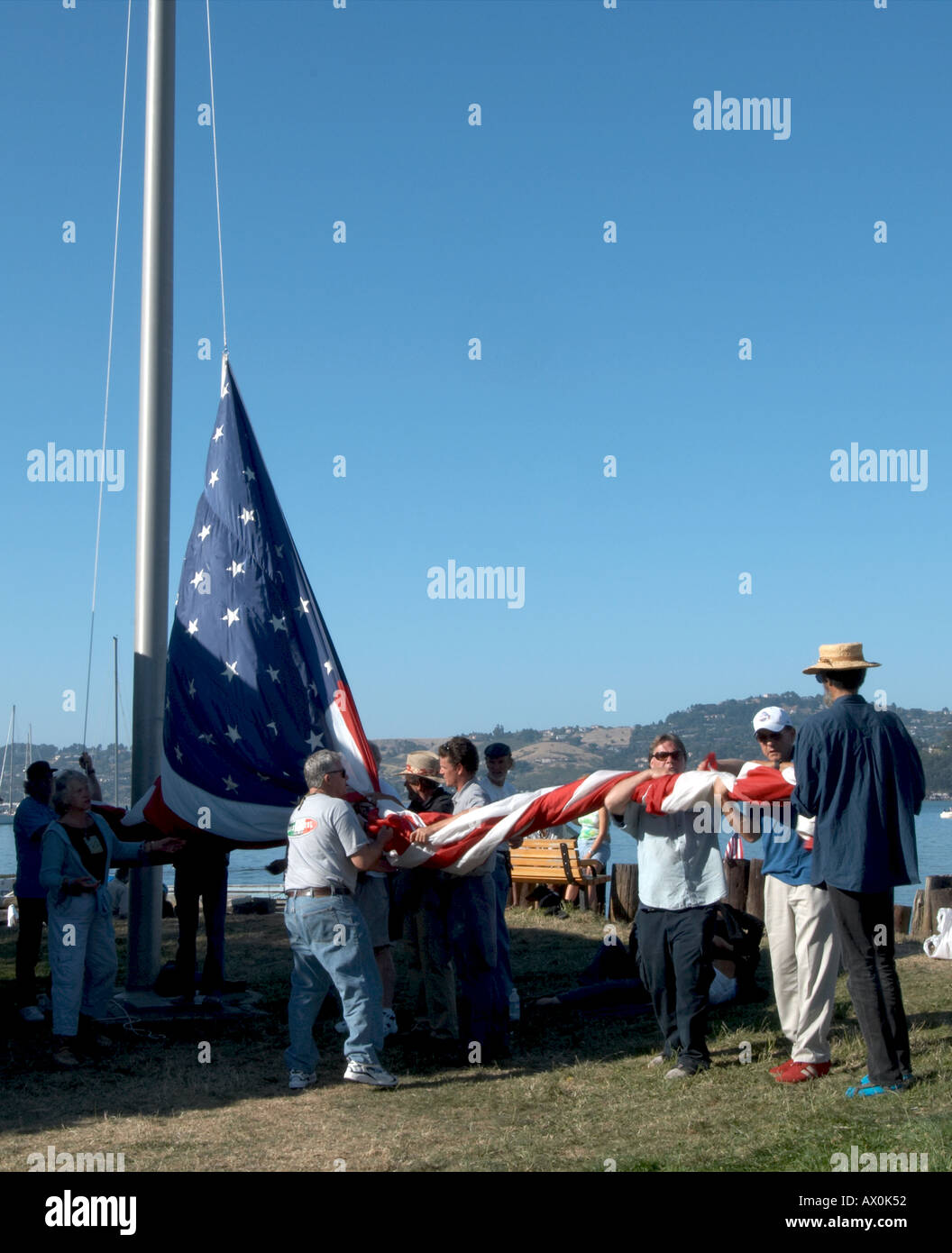 Lowering the american flag hi-res stock photography and images - Alamy