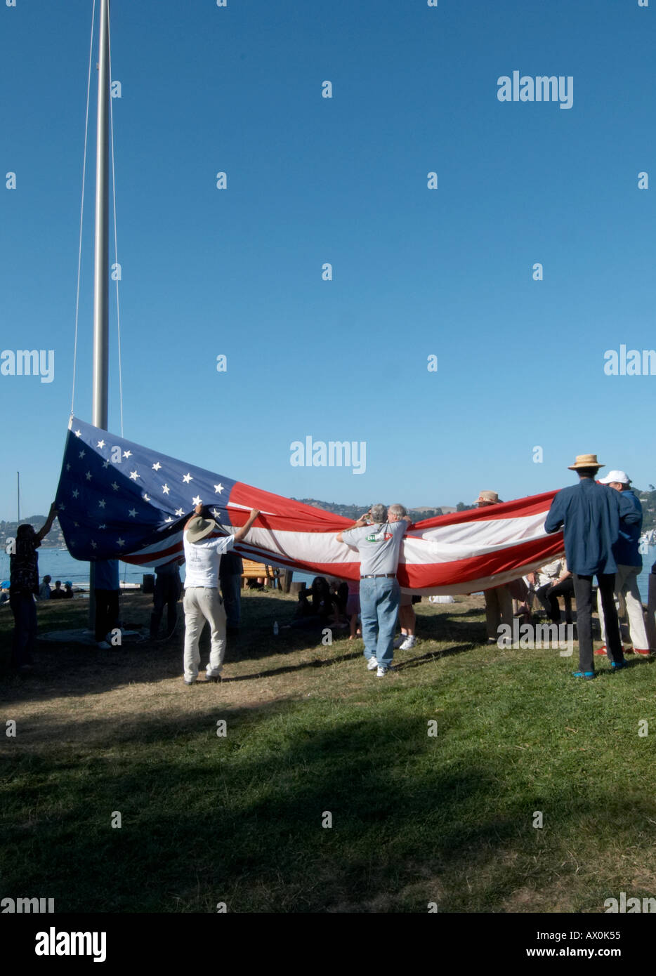 Group of men lowering the American flag on the 4th of July in sausalito ...
