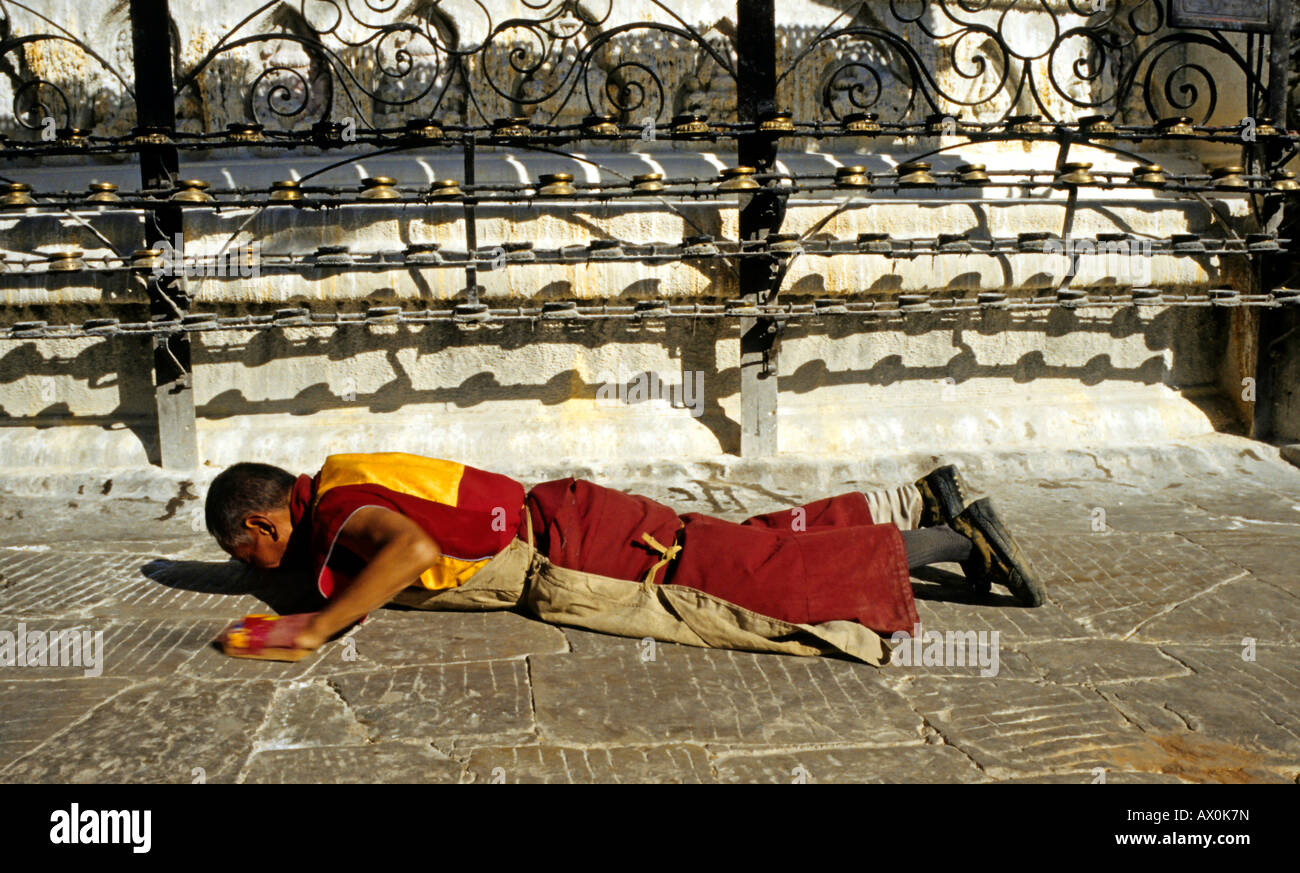 Buddhist monk prostrating in shrine, Svayambhunath, Nepal, Asia Stock ...