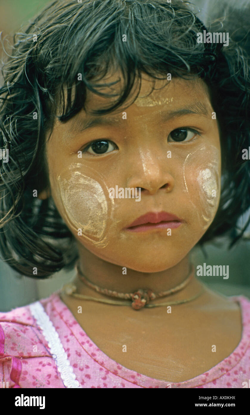 Girl wearing tanaka make-up, circular designs on face, Myanmar (Burma ...