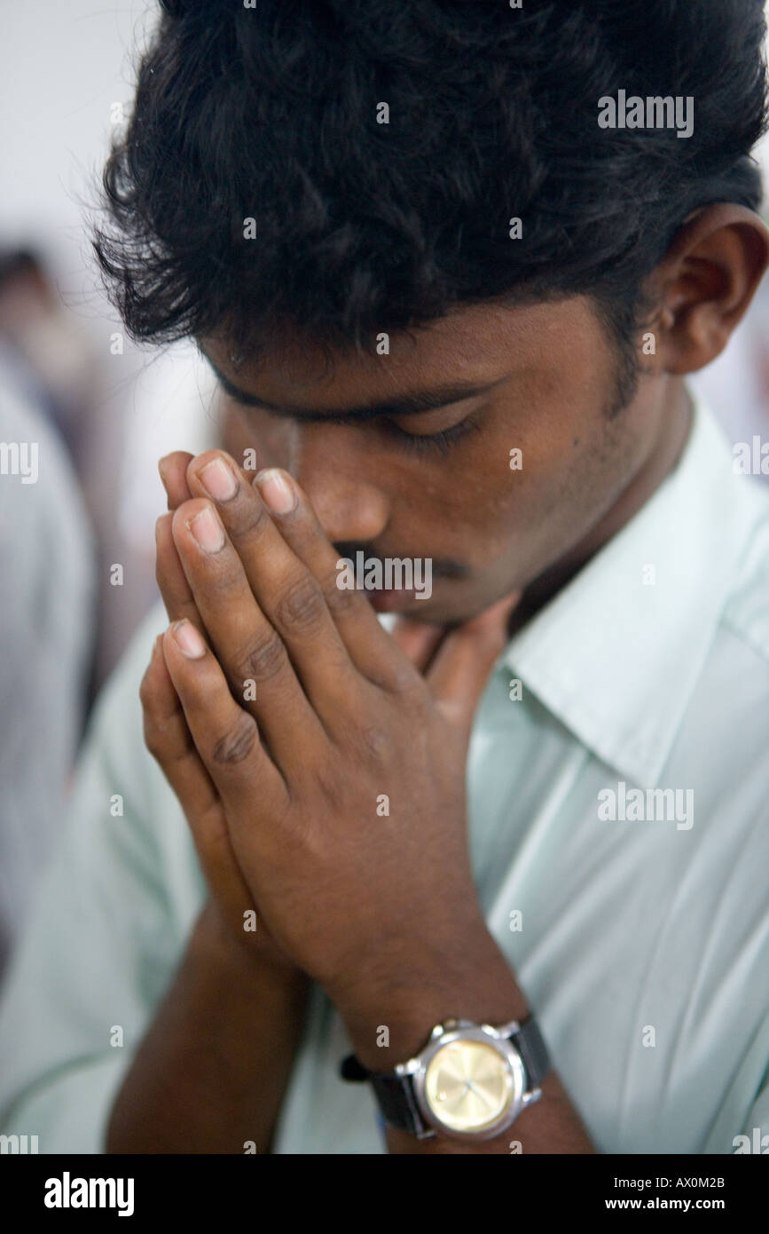 Young man praying in a Christian church in Hyderabad India Stock Photo ...