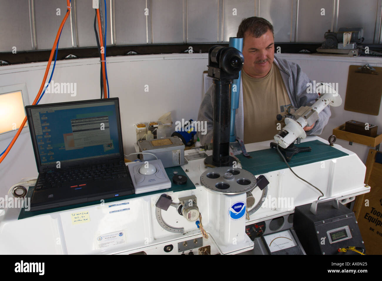 Technician with equipment at the NOAA Earth System Research Laboratory ...