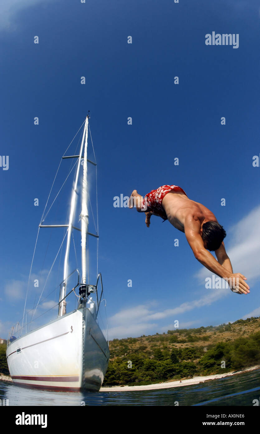man diving from yacht in sunny sea Stock Photo - Alamy