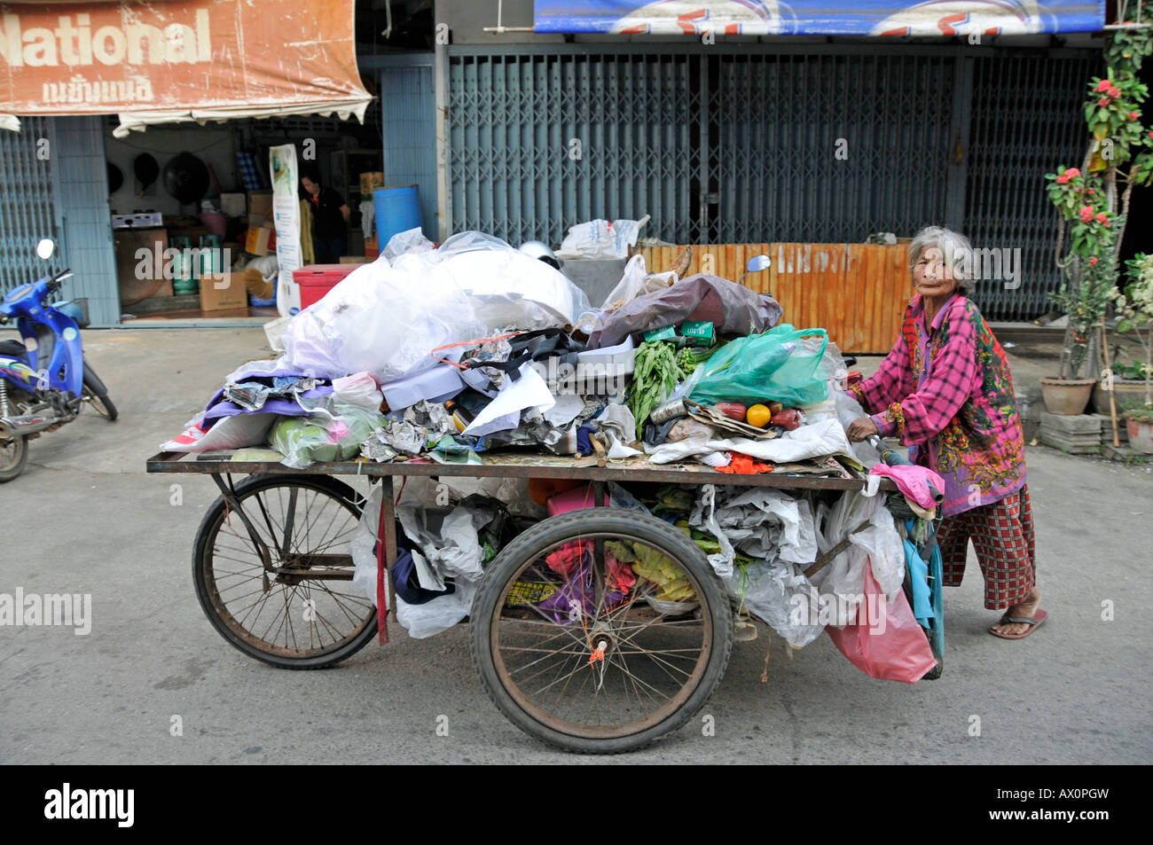 Old-age poverty: woman collecting garbage in Sukhothai, Thailand ...